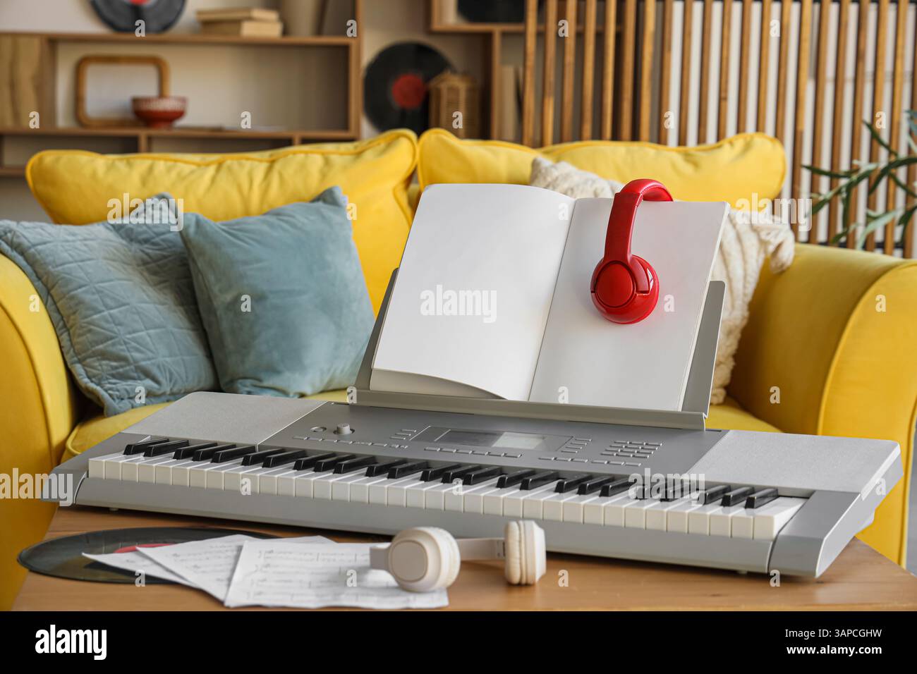 Synthesizer with note sheets and headphones in living room Stock Photo ...