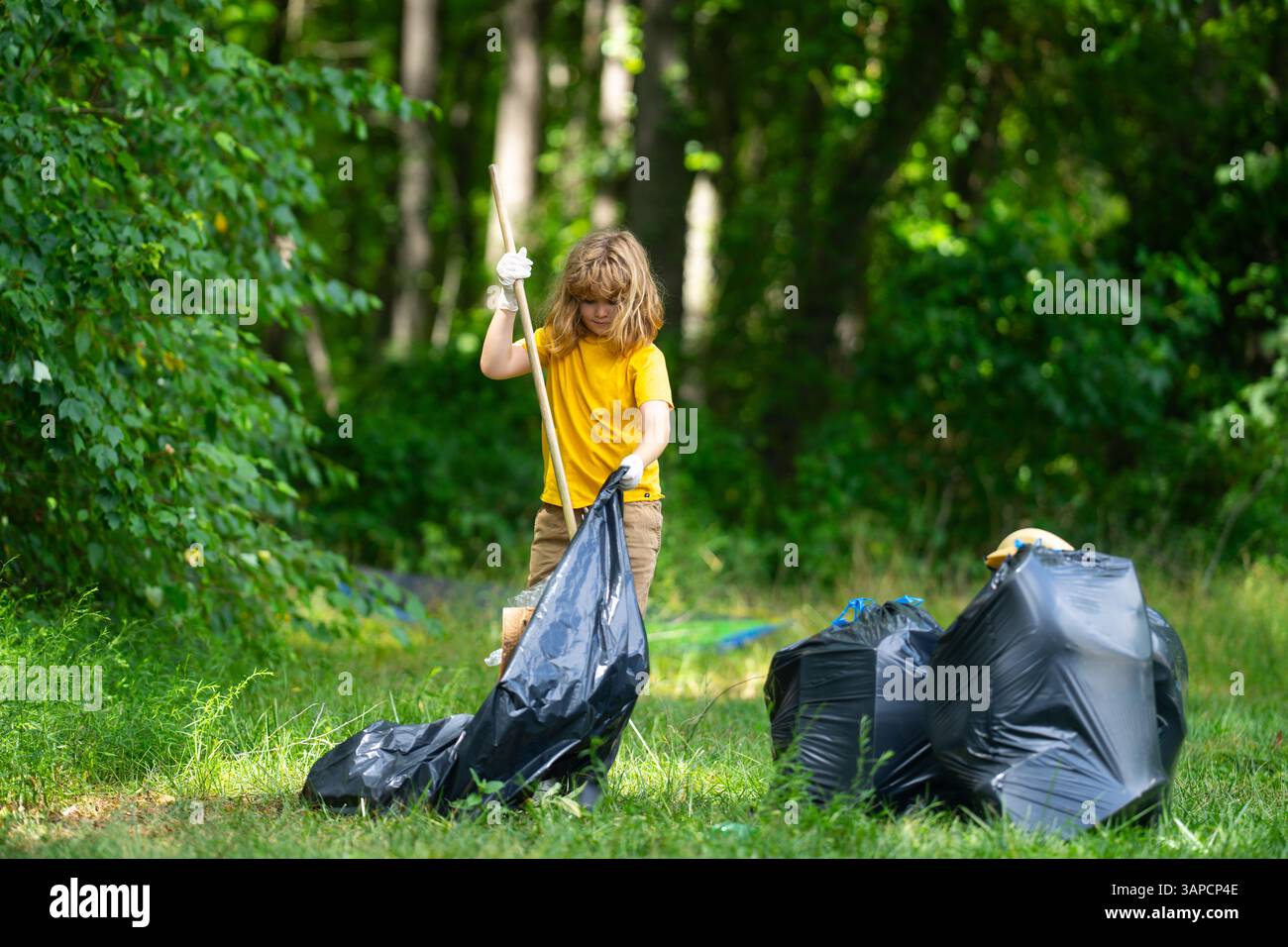 Global environmental pollution. Child collects plastic trash outdoor ...