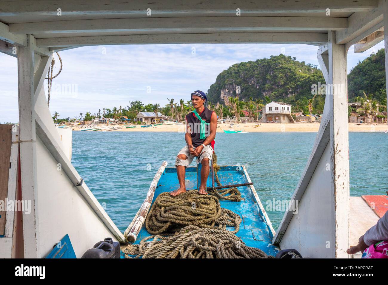 Local Filipino passenger sit inside a motorized boat as it travels ...