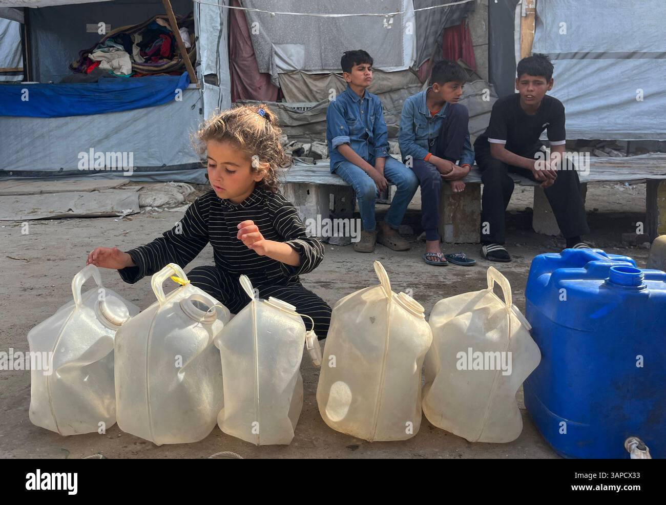 A water tanker distributes clean water to Palestinians in Gaza City A ...
