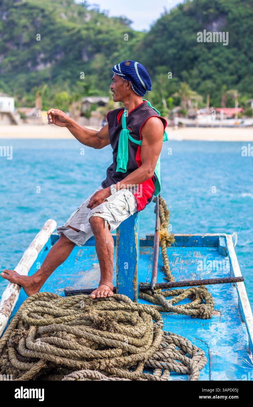 Local Filipino passenger sit inside a motorized boat as it travels ...