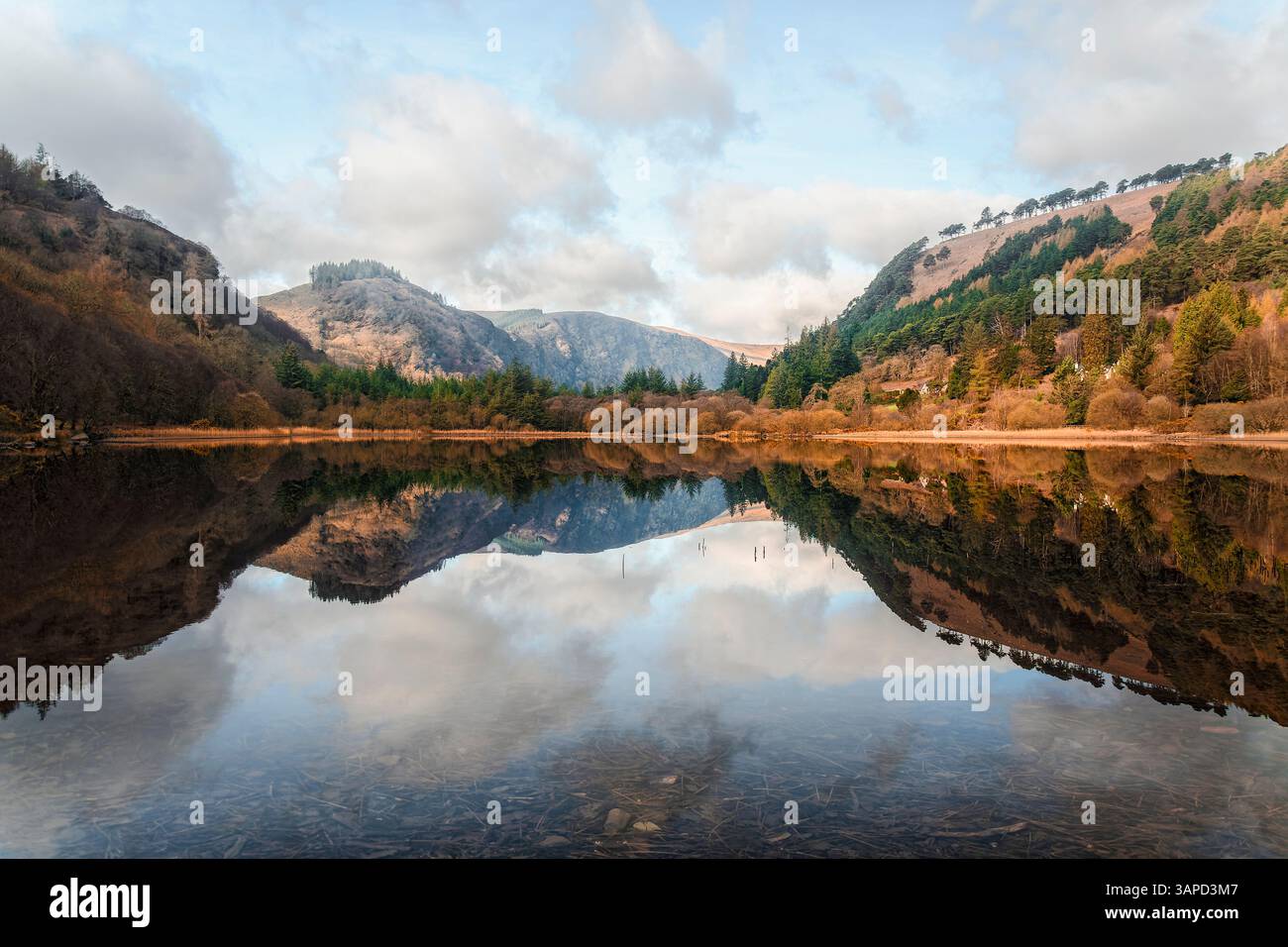 Lake reflection of mountain slopes at Glendalough, the tranquil beauty ...