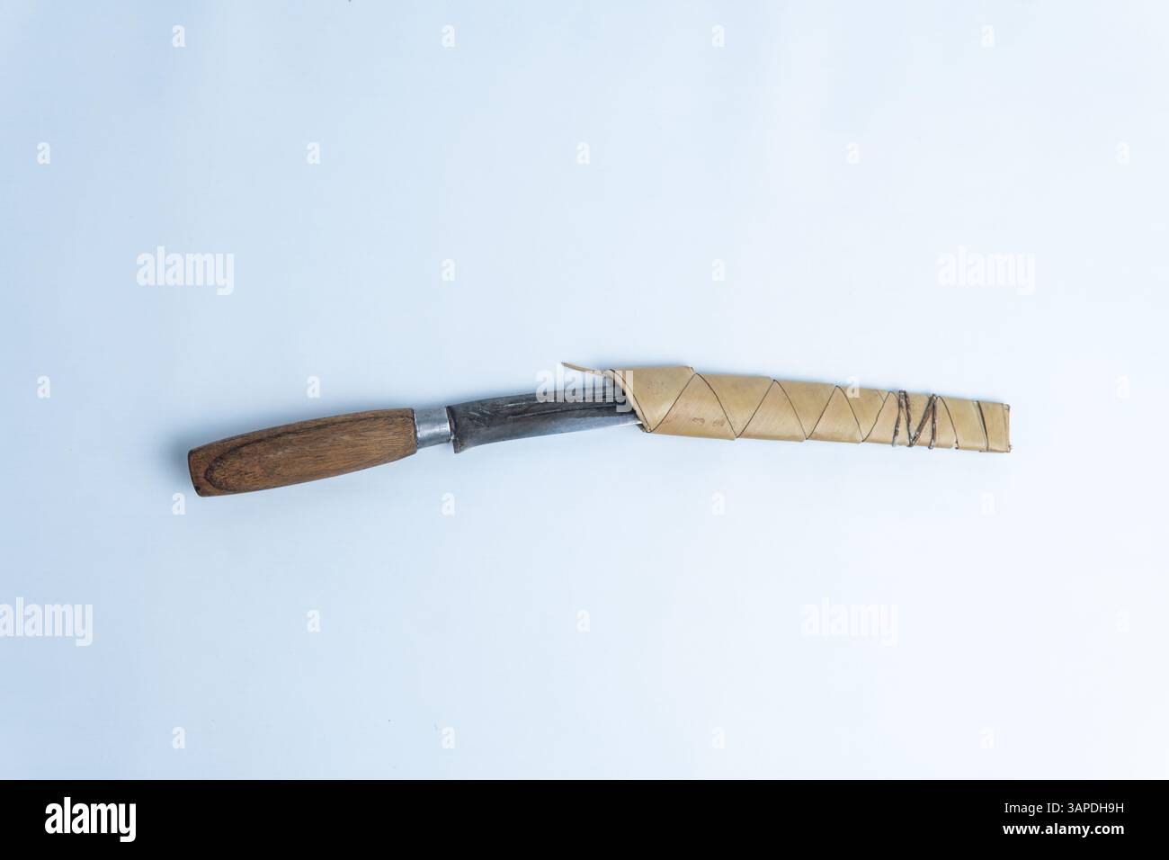 A close-up of a hand holding a traditional knife from Flores, Indonesia ...