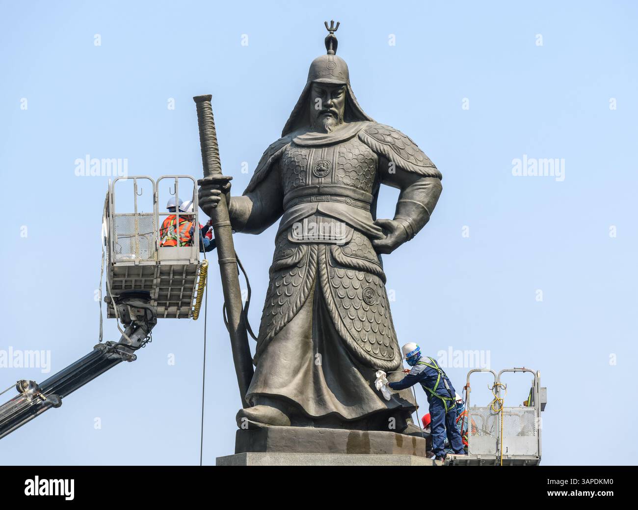 Workers clean the statue of Admiral Yi Sun-shin, who won a major naval ...