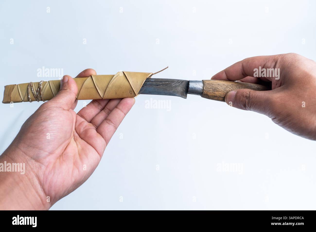 A close-up of a hand holding a traditional knife from Flores, Indonesia ...
