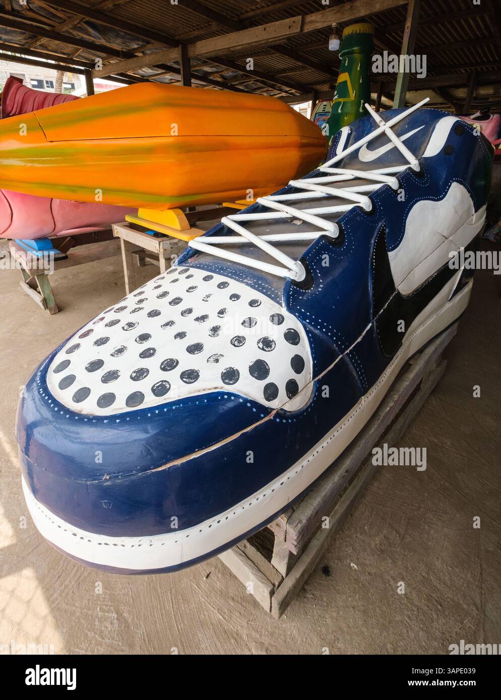 Accra, Ghana. Coffin in Shape of a Tennis Shoe. Papaya in background ...