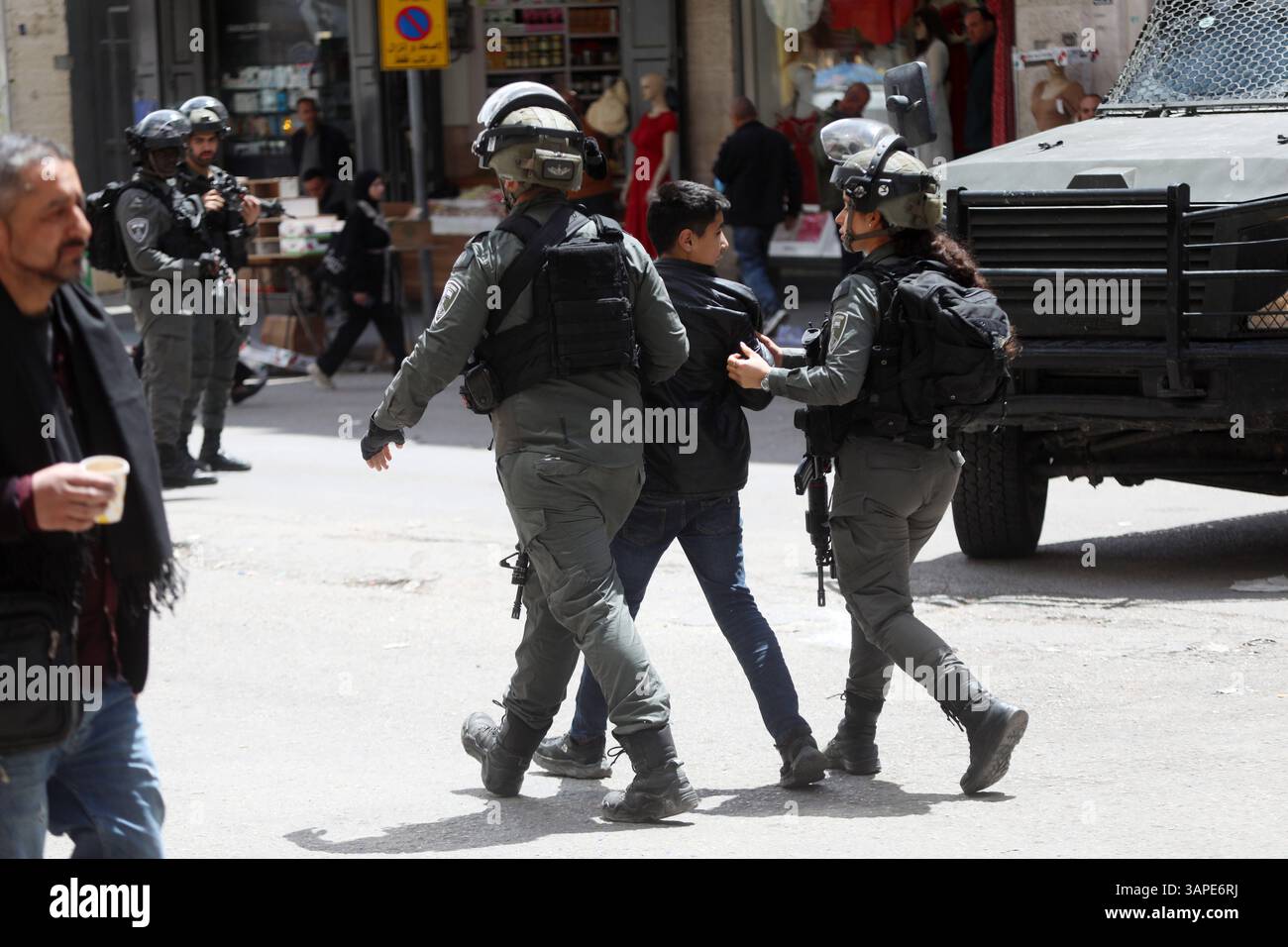 Israeli forces detain a Palestinian child during a raid as the army ...