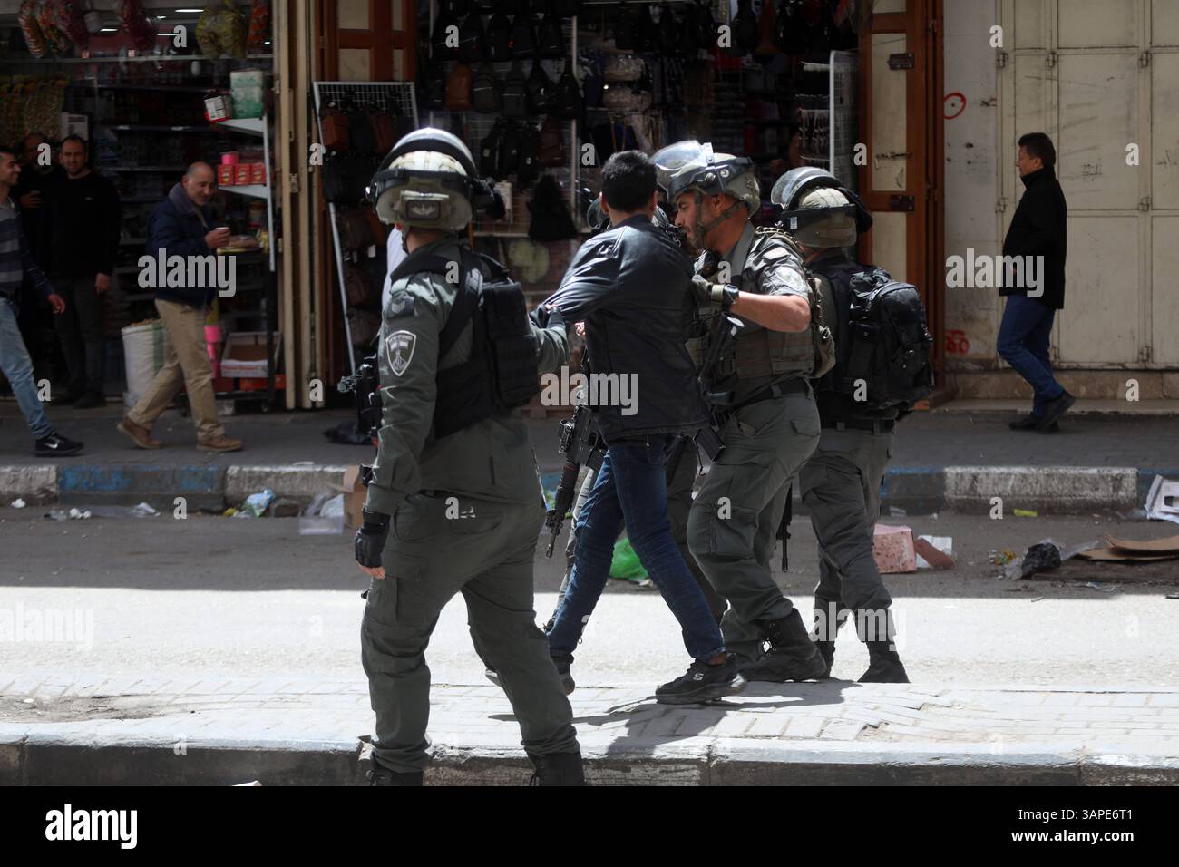 Israeli forces detain a Palestinian child during a raid as the army ...