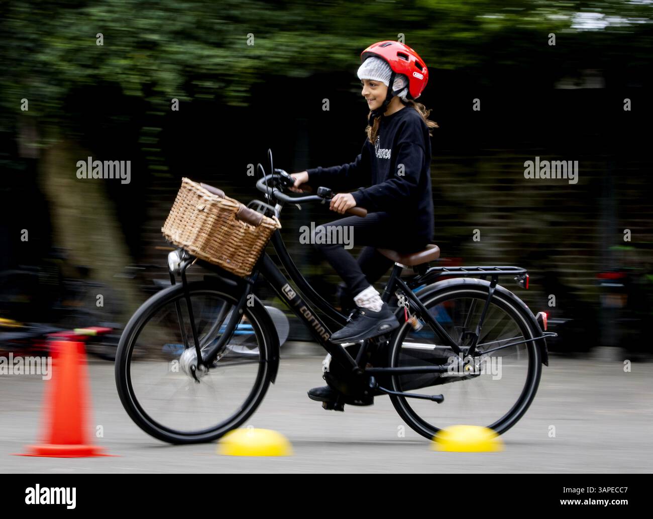 DEN HAAG - Elementary school students ride a bicycle with a bicycle ...