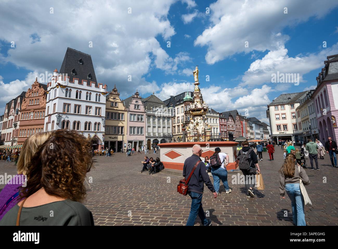 Trier, Germany. 14th Apr, 2025. People walk through Trier's main market ...