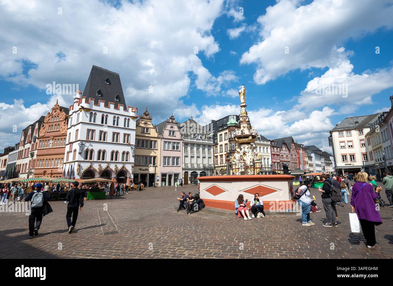 Trier, Germany. 14th Apr, 2025. People walk through Trier's main market ...