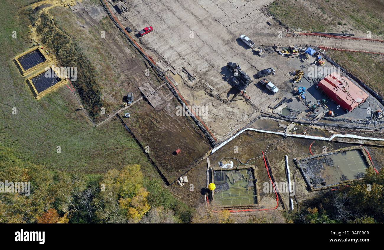 FILE - Crews prepare for remediation to temporarily reduce the confined ...