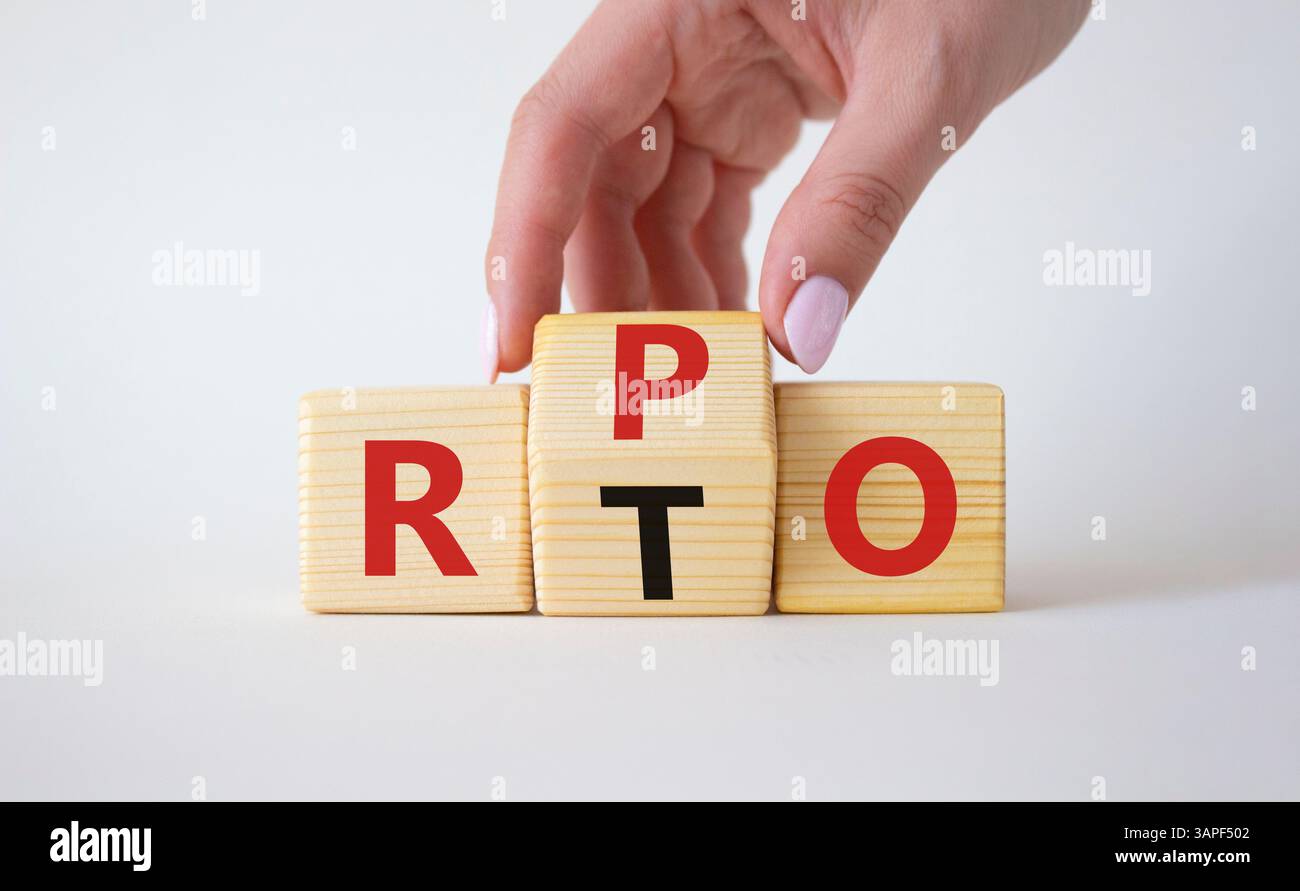 RPO vs RTO symbol. Businessman hand turns wooden cubes and changes the ...
