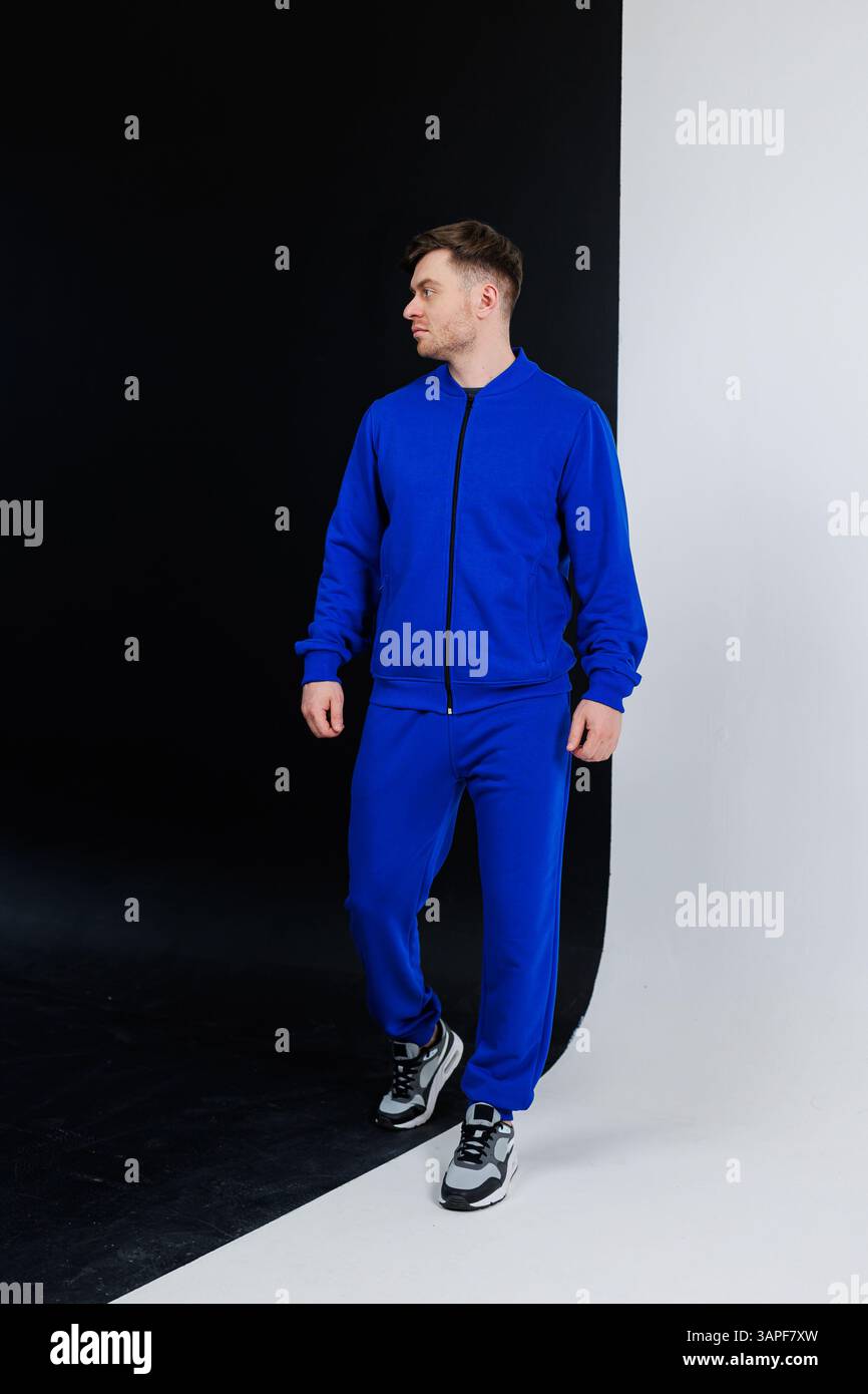 In a modern studio, a fashion model elegantly displays a vibrant blue ...