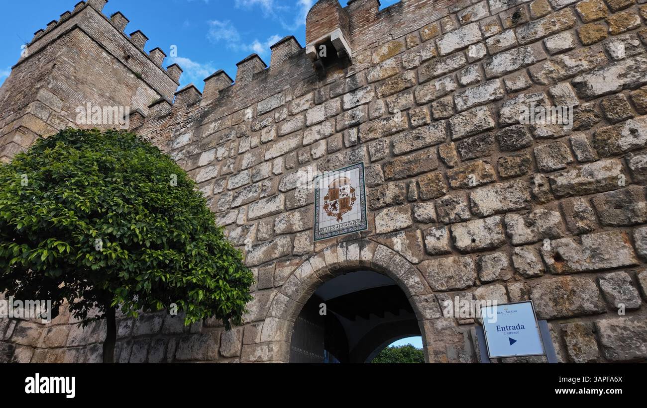Low angle view of the impressive stone walls of Real Alcazar Palace in ...