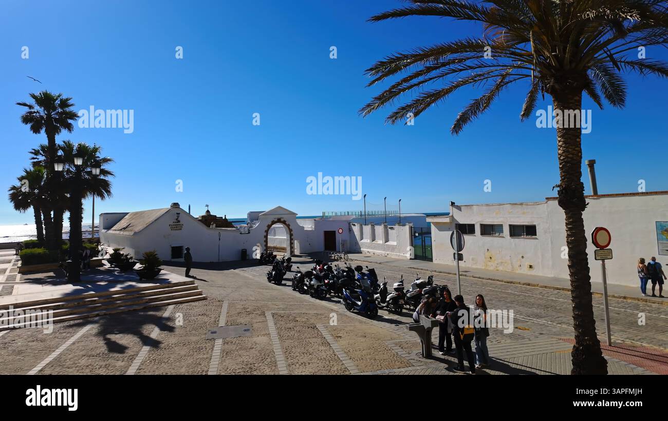 Group of tourists reading a map in Cadiz, near Playa de la Caleta, with ...