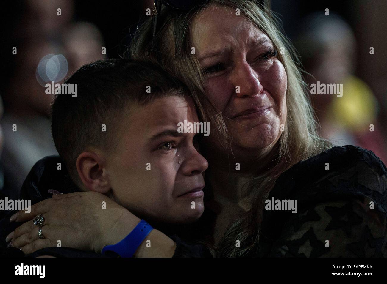 Mother with her son cry during farewell ceremony of Maksym Martynenko, 11, Natalia Martynenko ...