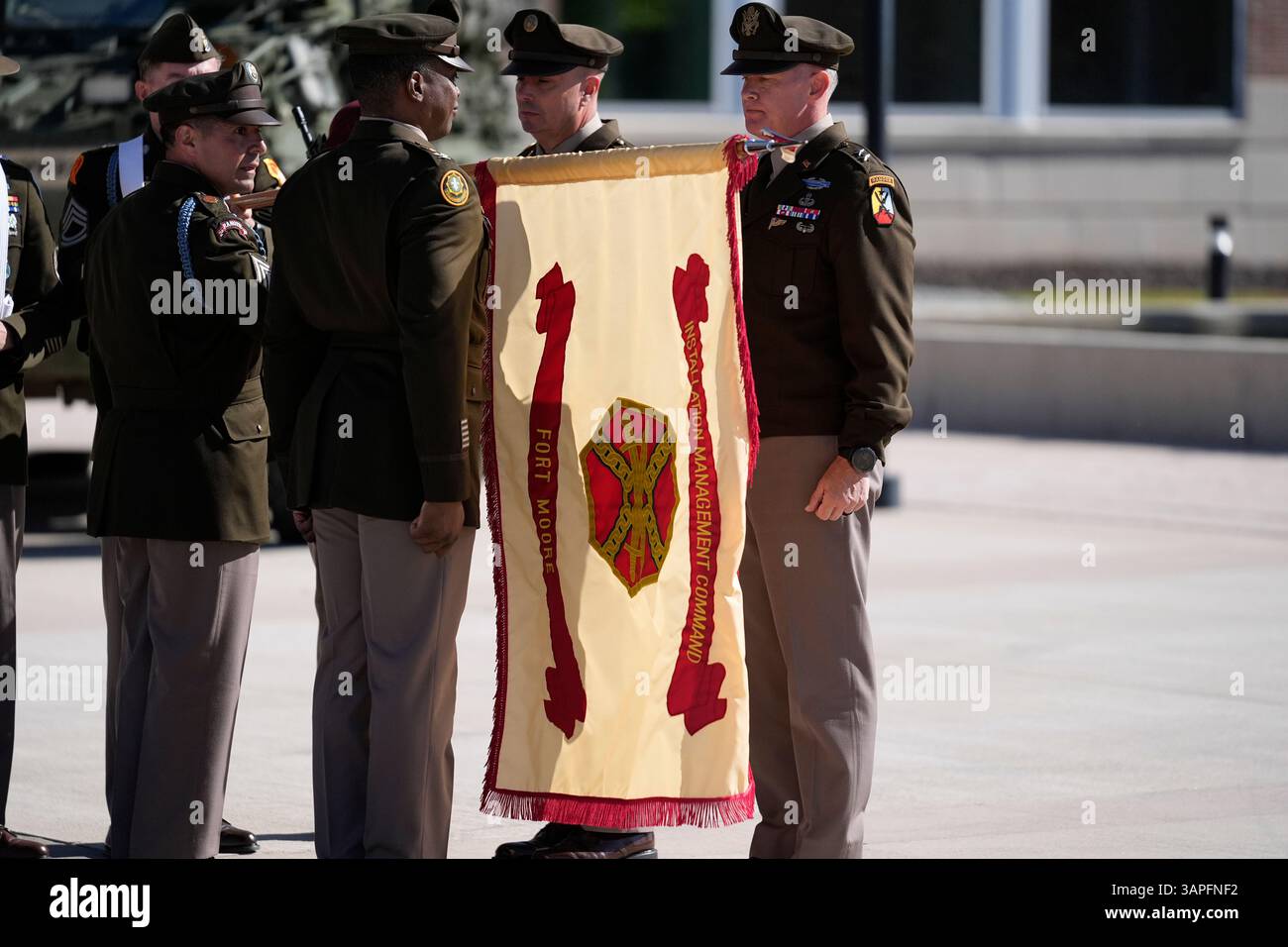 Members of the Army military change a flag from Fort Moore to Fort ...