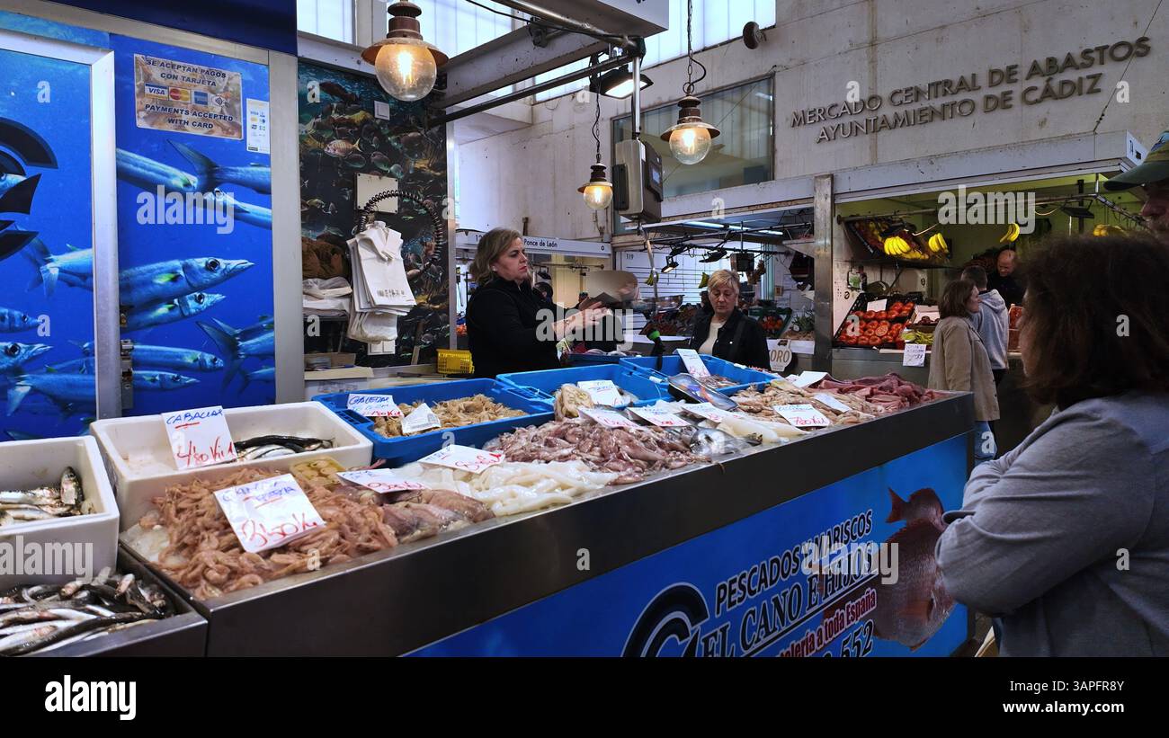 Fishmonger serving fresh fish to customers inside the Mercado Central ...