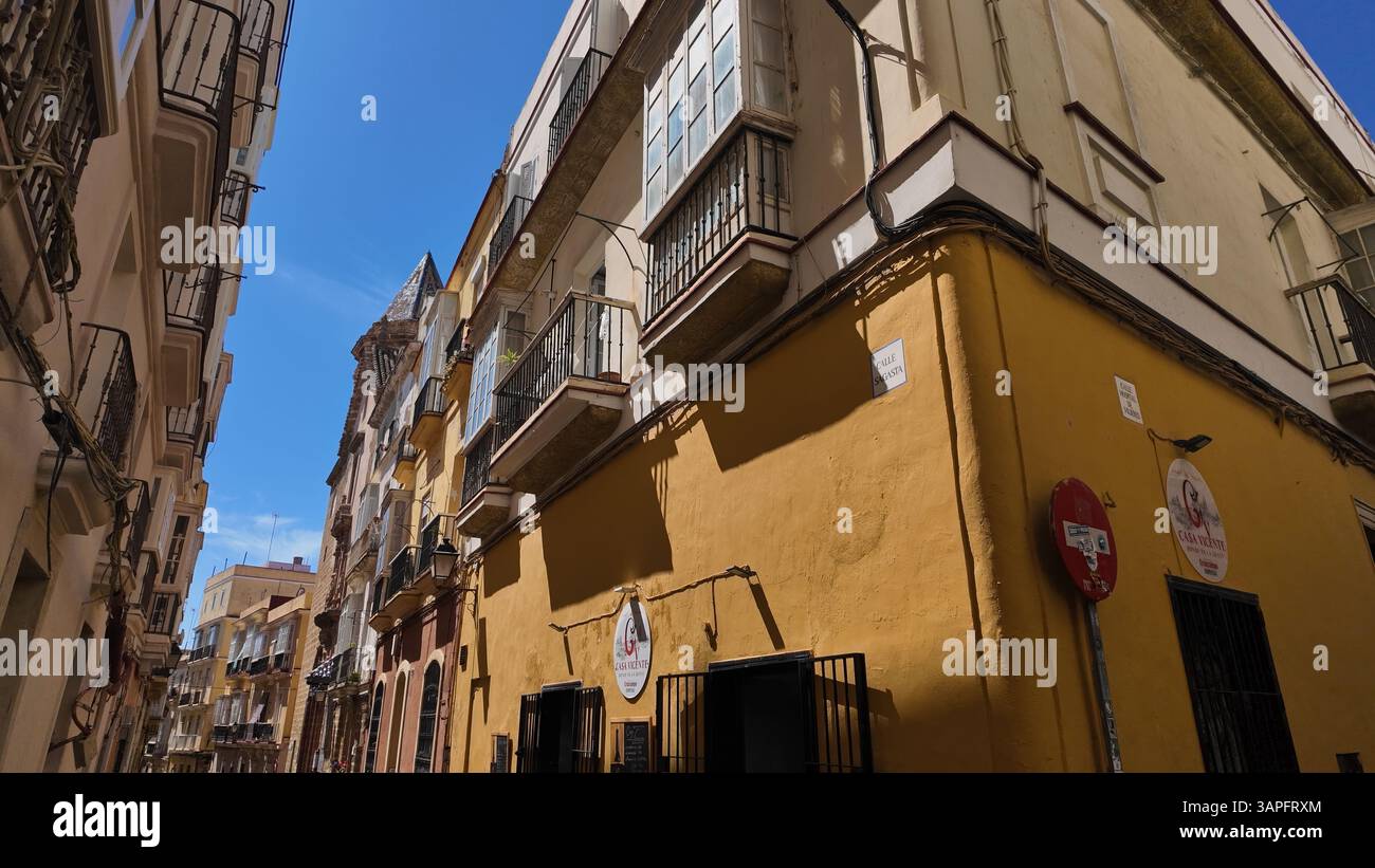 Traditional architecture characterizing a narrow street in Cadiz, Spain ...