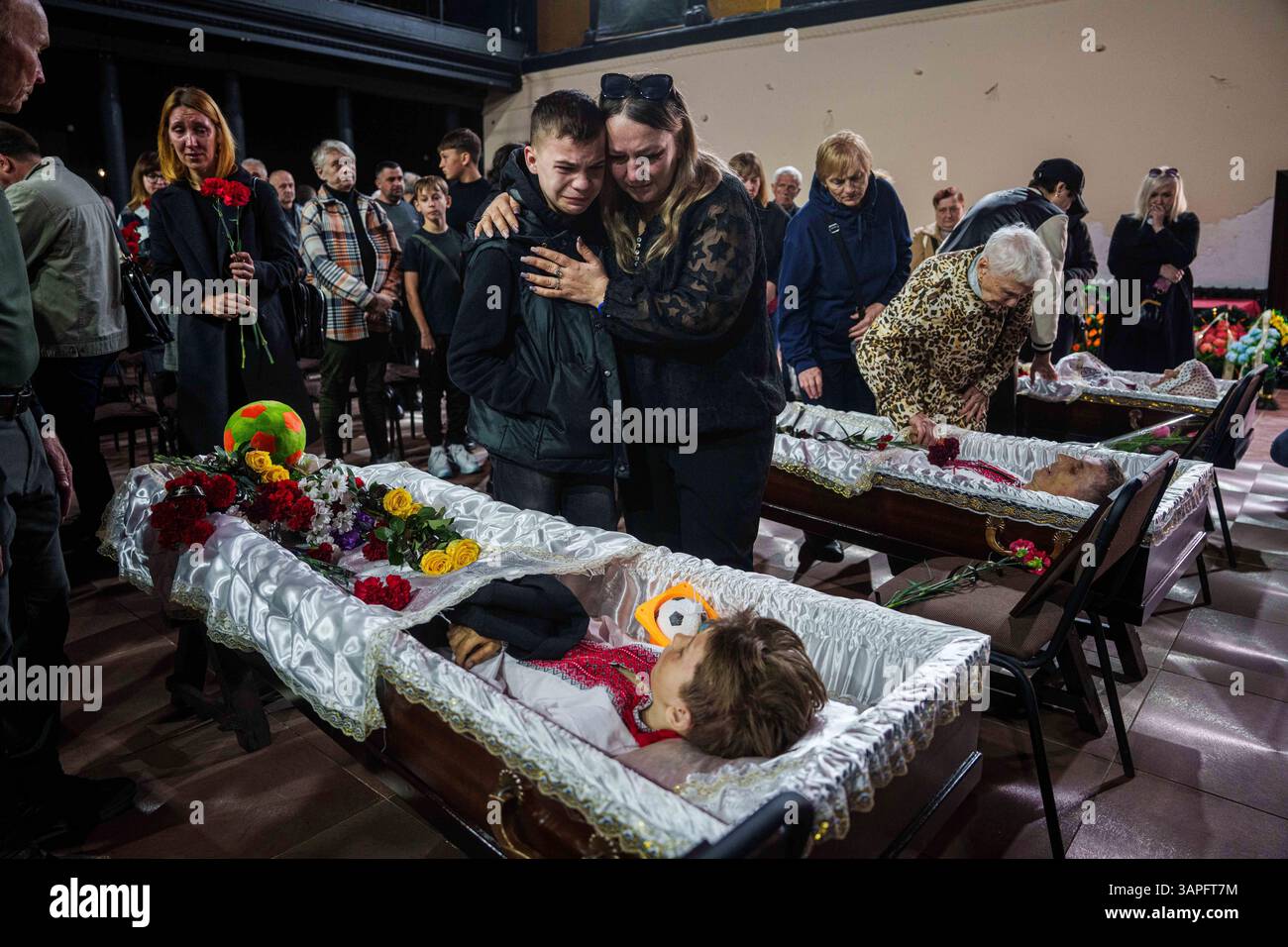 Friends come to pay last respects to the family, Maksym Martynenko, 11, Natalia Martynenko, 49 ...