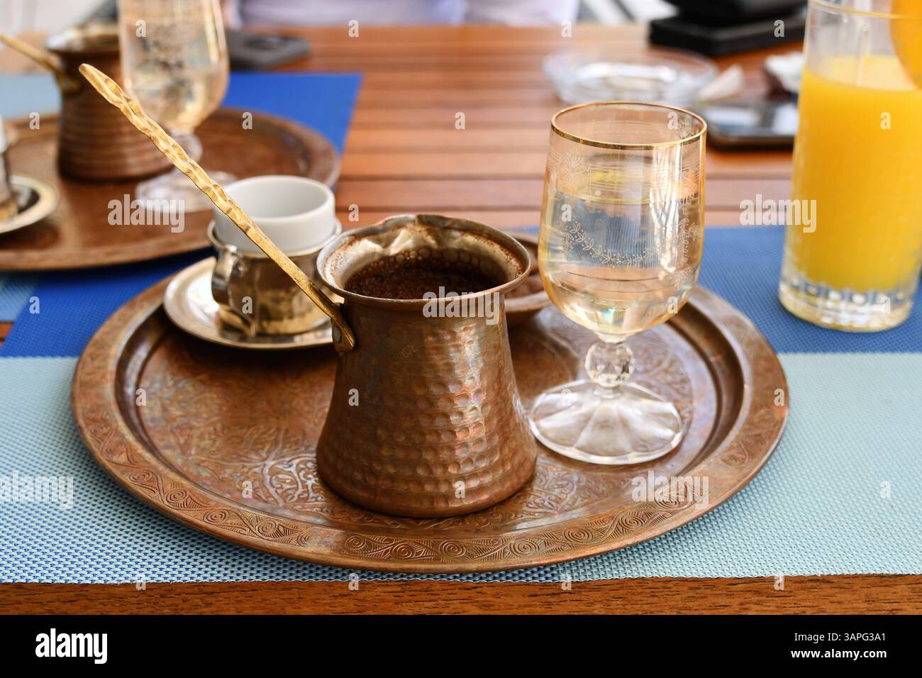 Qahwa. Traditional Omani coffee with cardamom in a copper cezve served ...