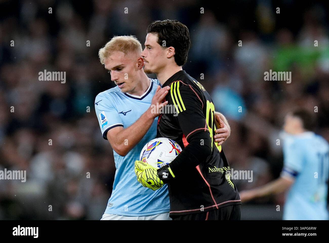 Gustav Isaksen of SS Lazio hugs Mile Svilar of AS Roma during the Serie ...