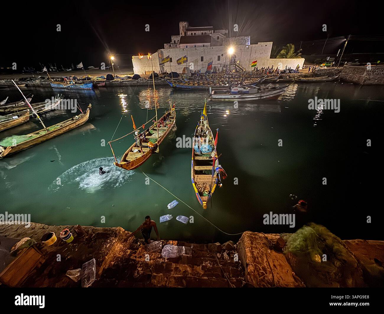 Ghana, Elmina. Fishing Boats in front of St. George Castle at Night ...