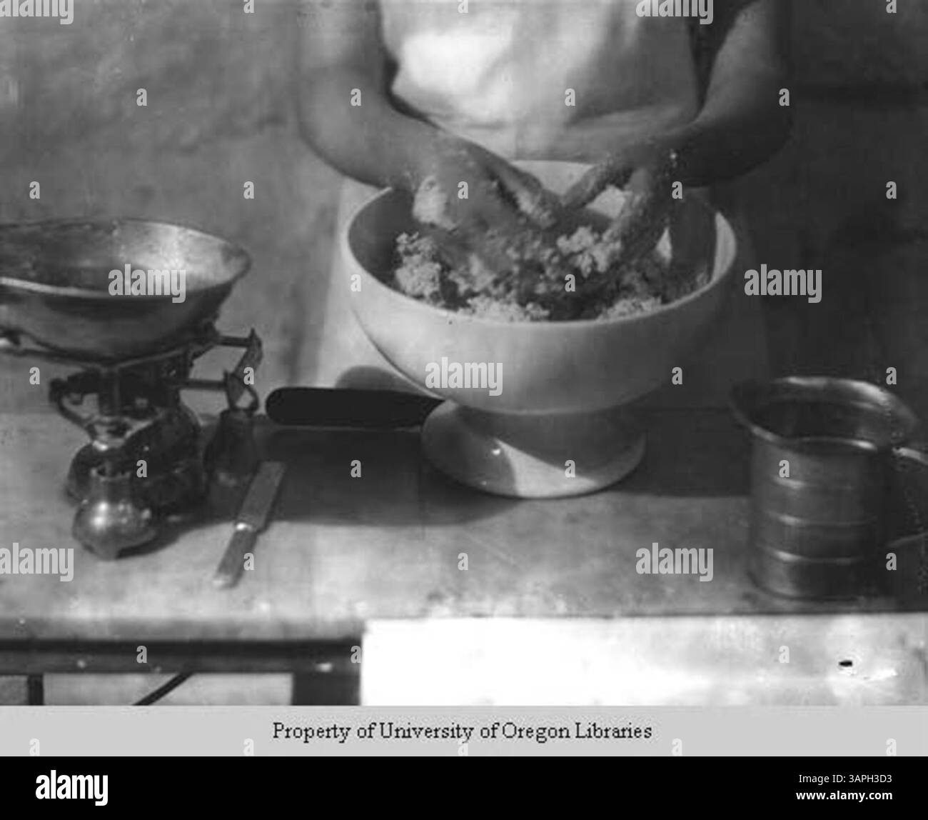 This photograph shows a woman mixing ingredients by hand at the Bakery ...