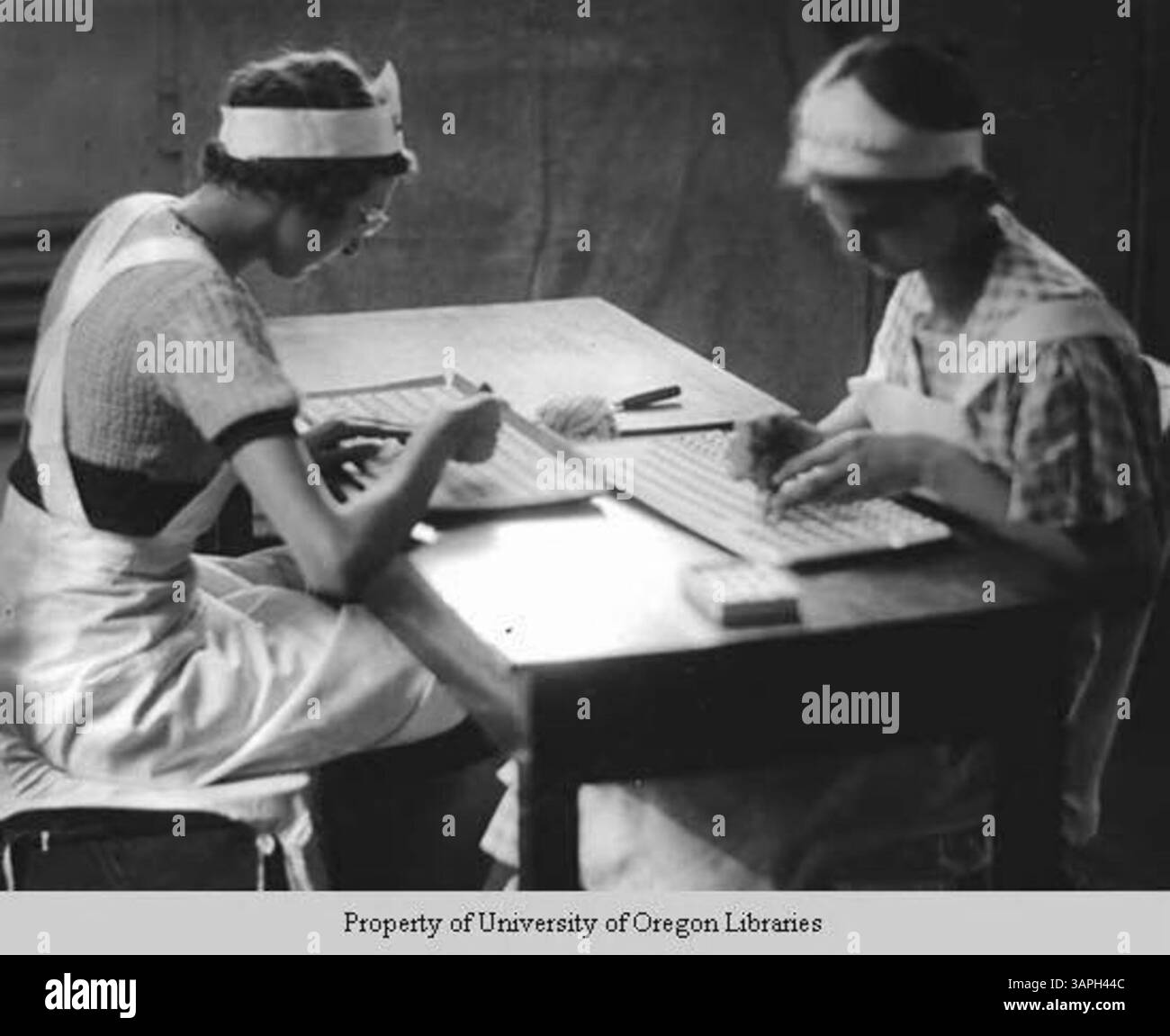 This photograph shows two young women making molded candy in the Candy ...