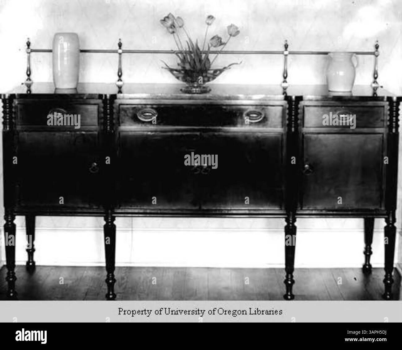 Photograph of a sideboard displaying flowers and two vases, captured in ...