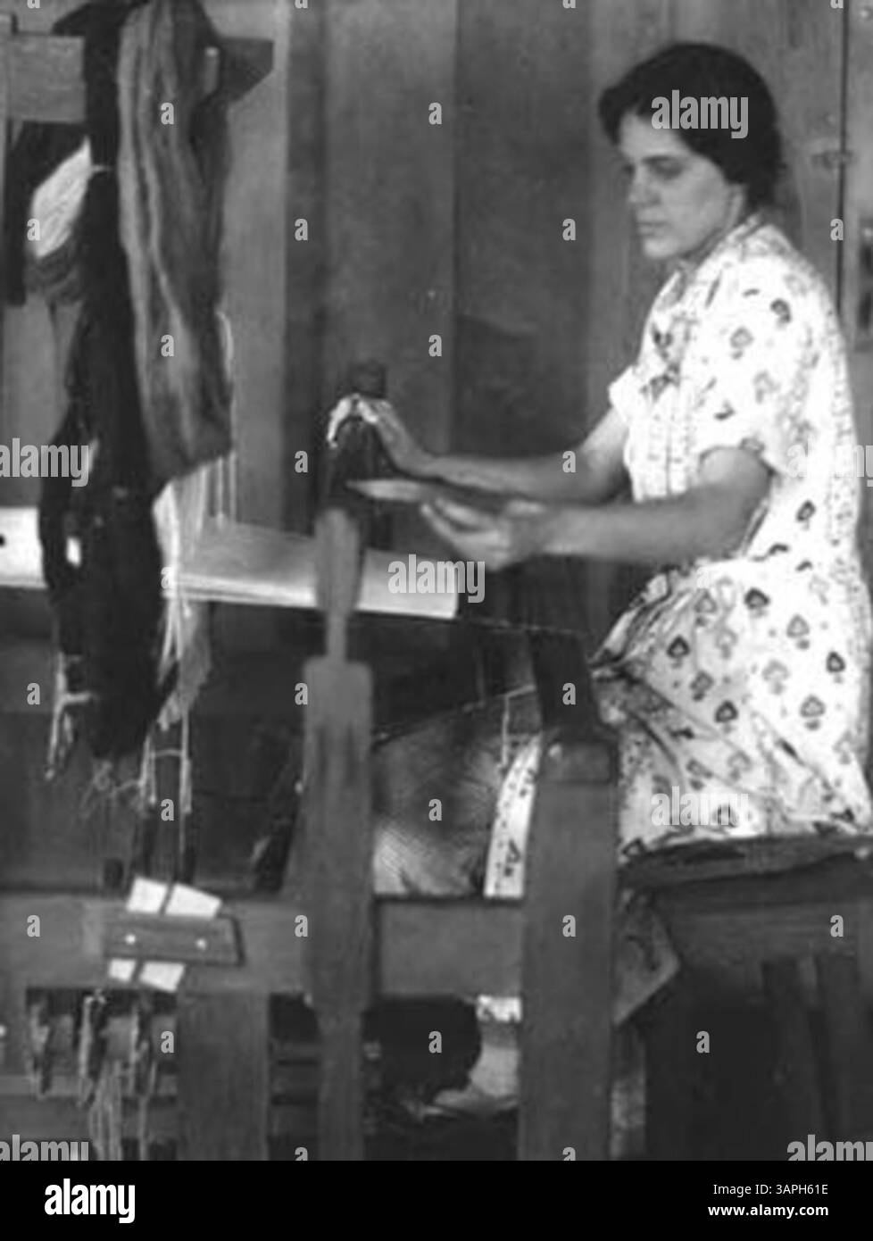 Photograph of Jane Chase spinning and weaving at a loom, part of the ...