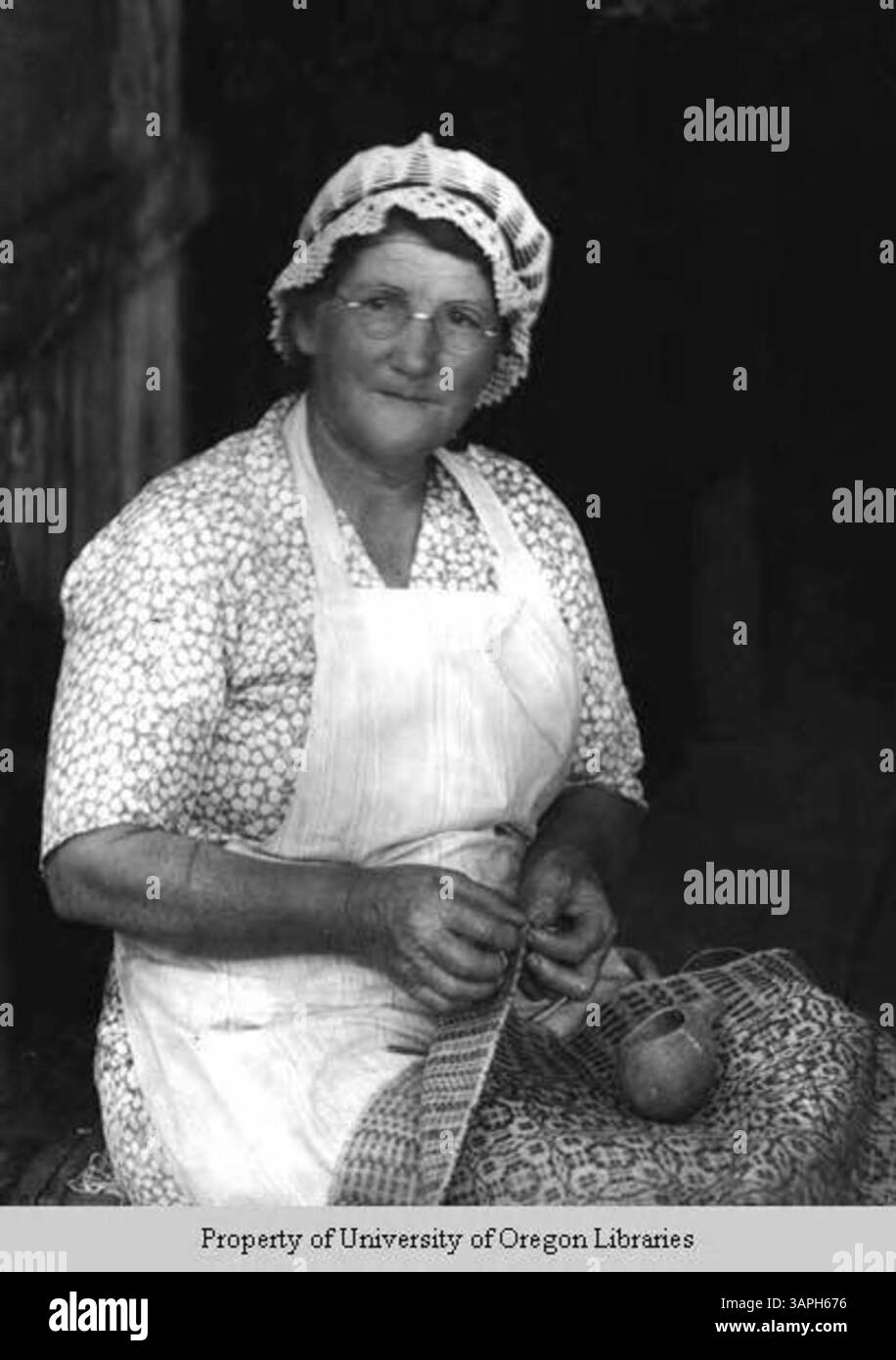 A photograph of S.U. Wyatt, a weaver, dyer, and spinner, holding woven ...