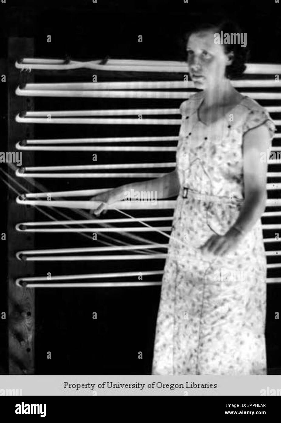 This photograph features Laura Trentham, a weaver, engaged in the ...