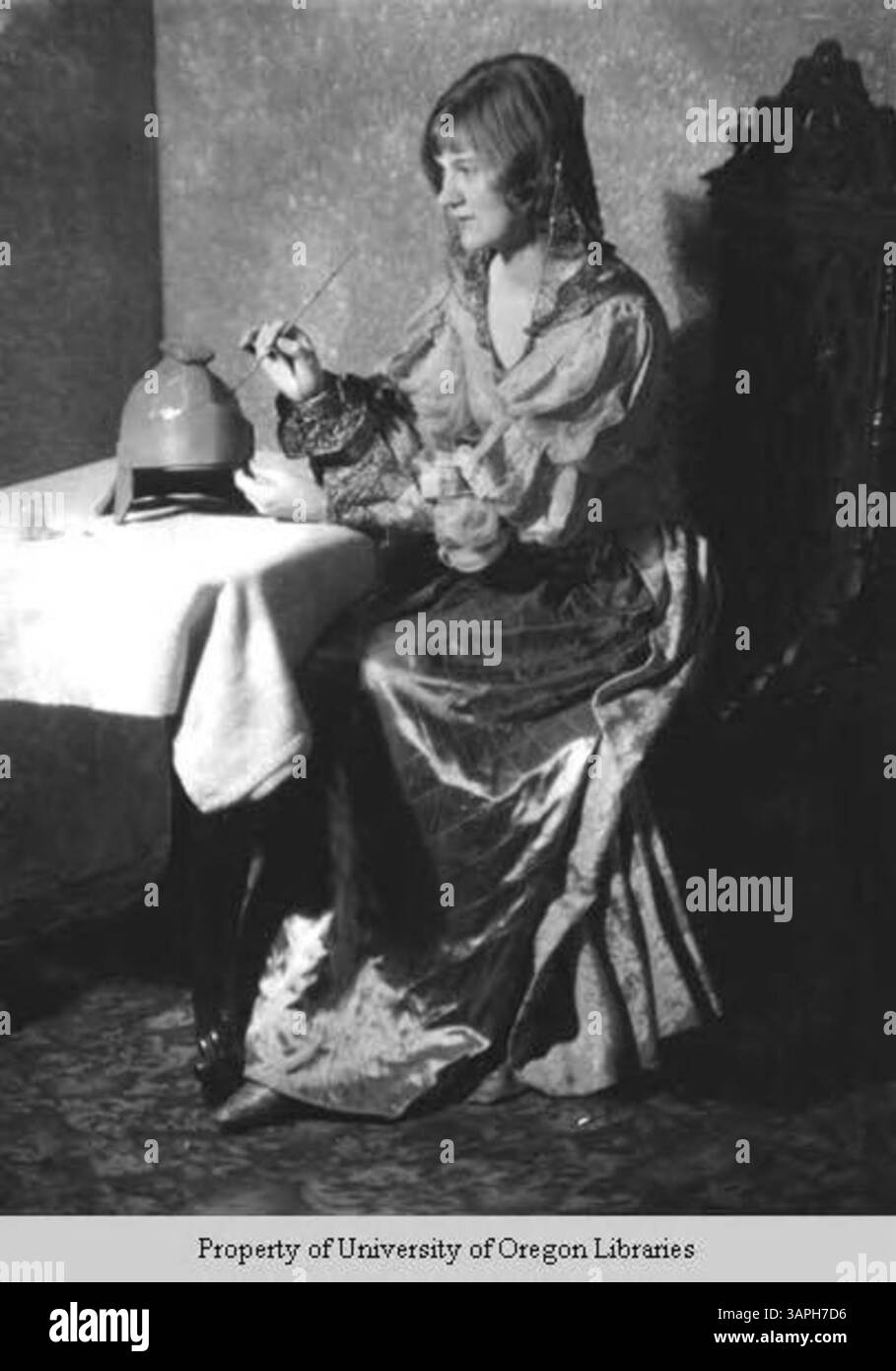 A young woman in an elegant gown is depicted painting a model of a ...