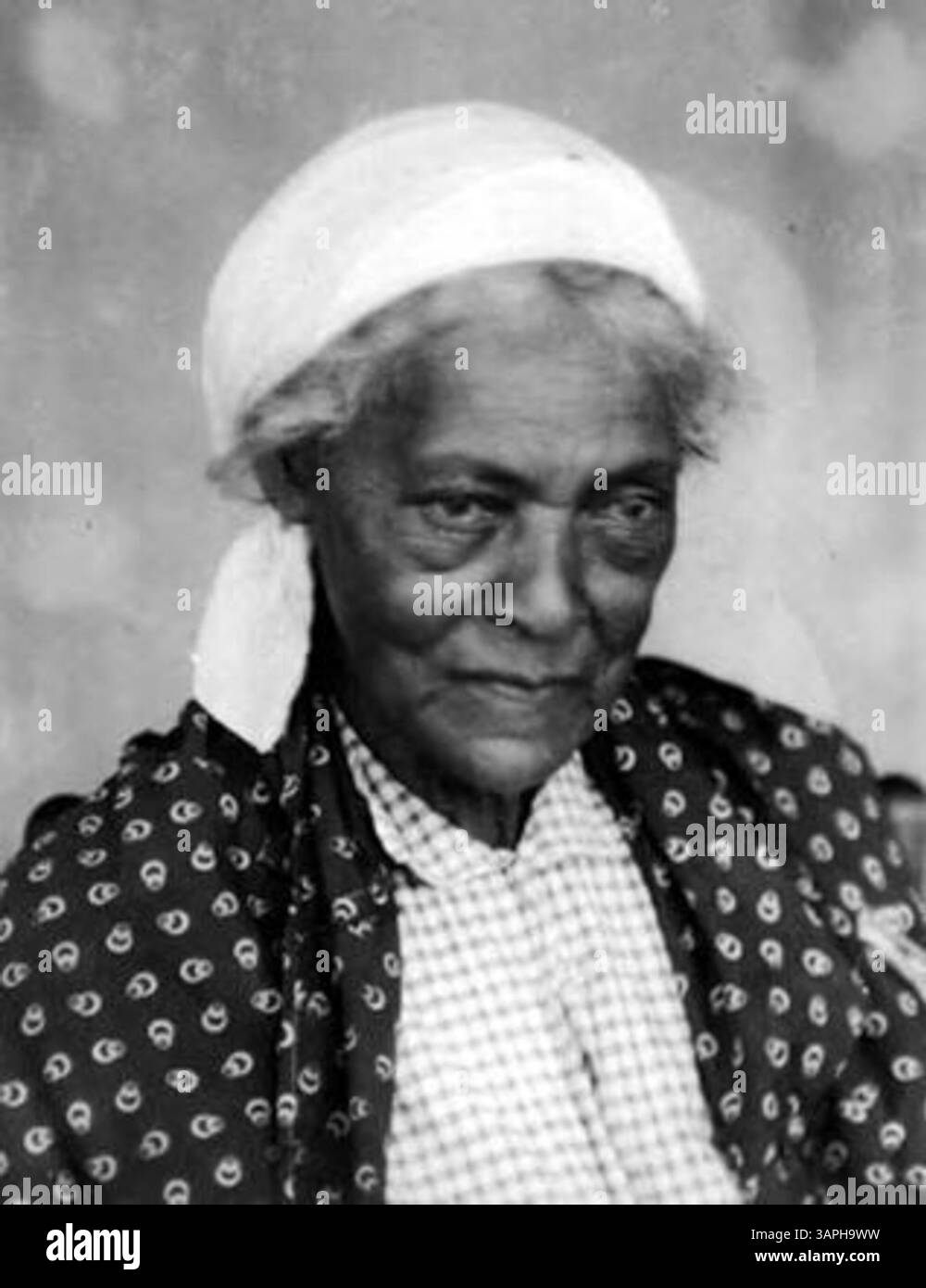 This photograph features an African-American woman wearing a white ...