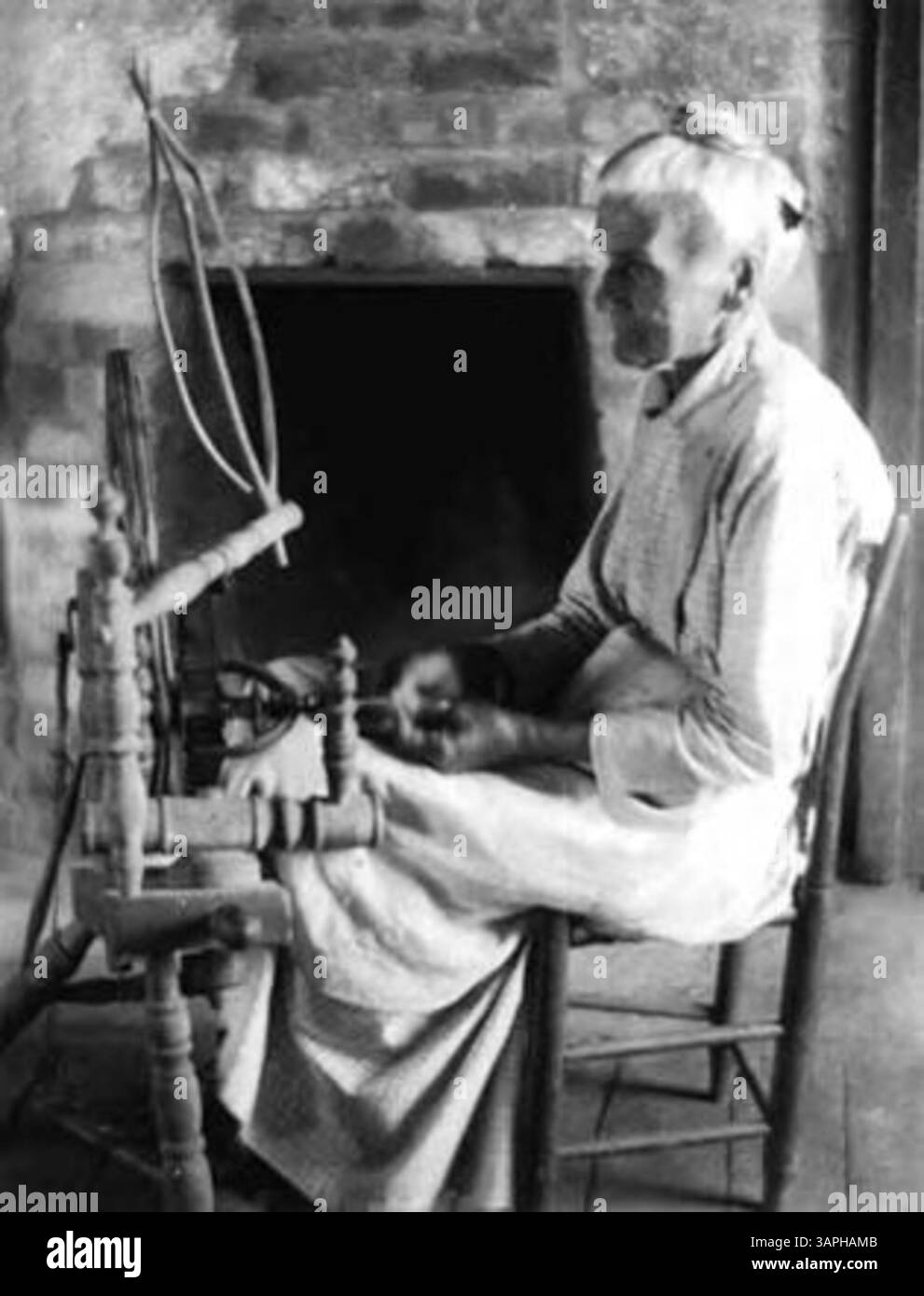 Photograph of a woman spinning, showcasing traditional textile work in ...