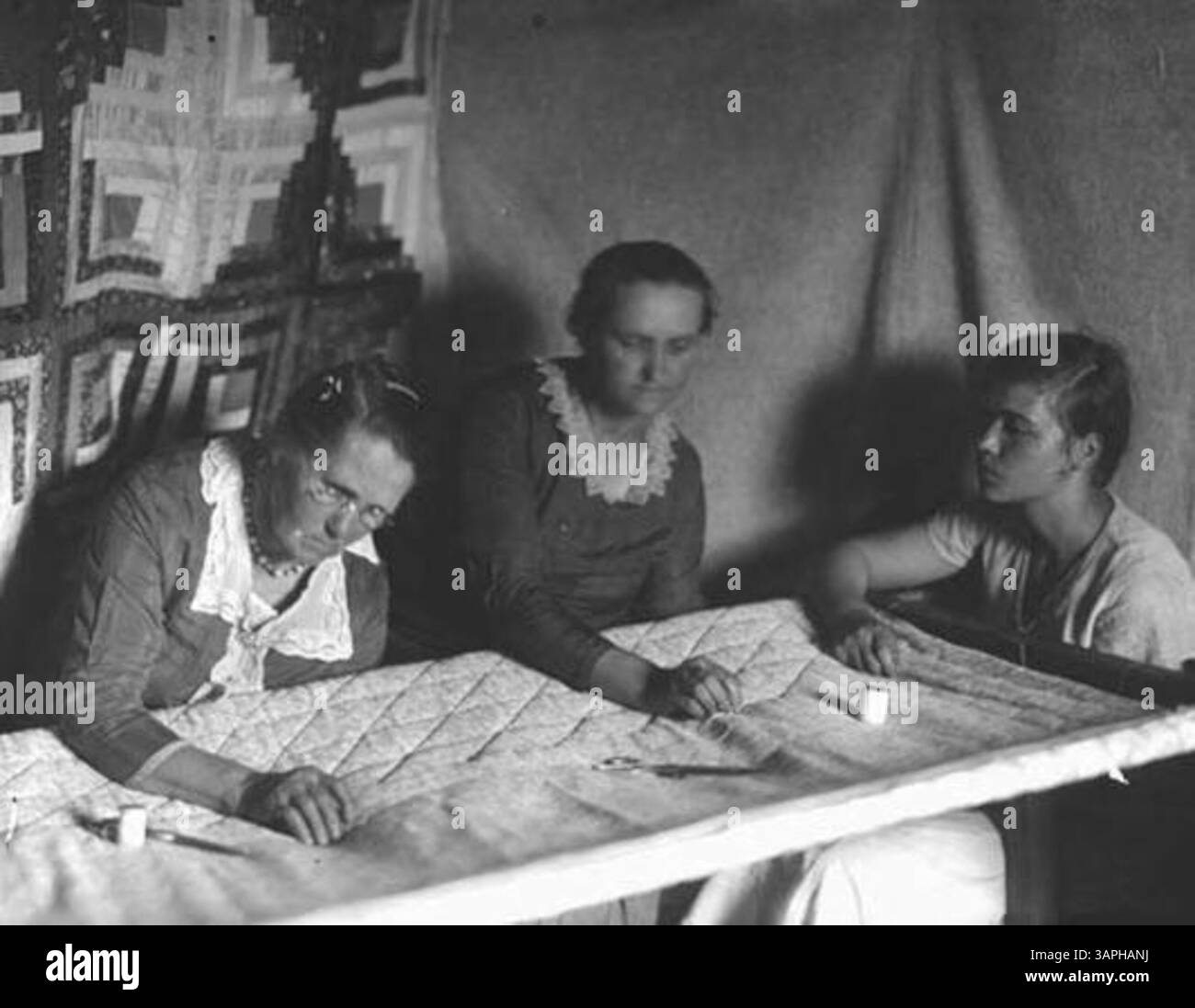Photograph of Ms. Ray Burnett with her mother and daughter quilting ...