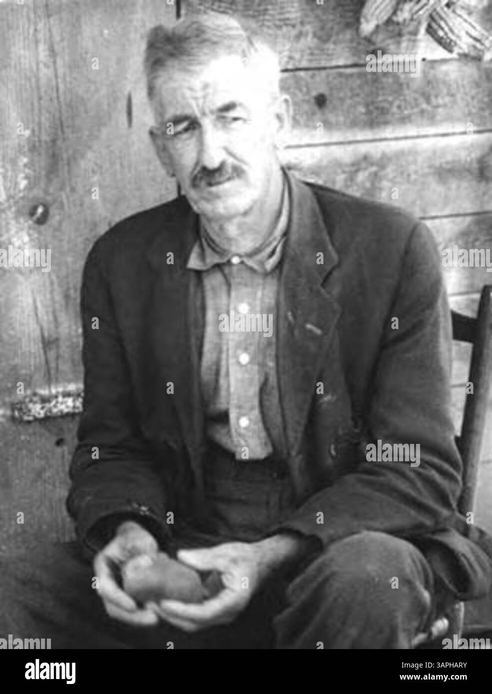 W.J. Martin is seen carving a pig in this photograph from the Doris ...