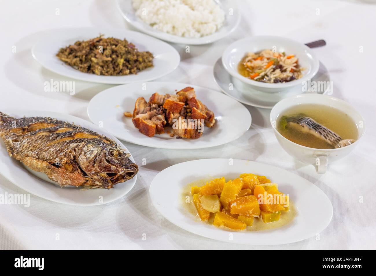 Lunch meal spread featuring fish, pork, and vegetables at a local ...