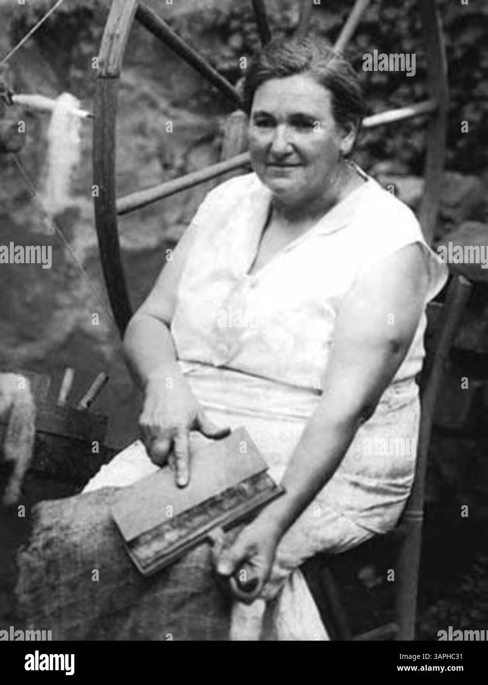 A photograph of Abigail Hall Ritchie engaged in spinning, demonstrating ...