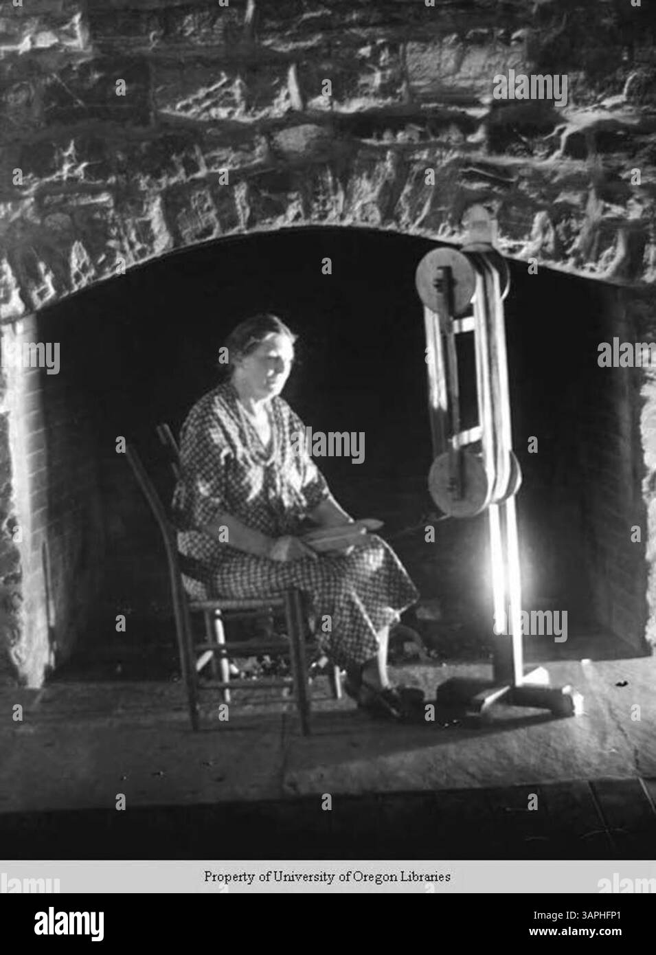 Photograph of Ms. Duffield, a spinner and weaver, winding thread by a ...