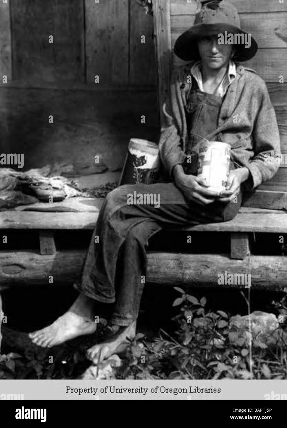 This photograph depicts Elsie Stewart, a tomboy, sitting on a cabin ...