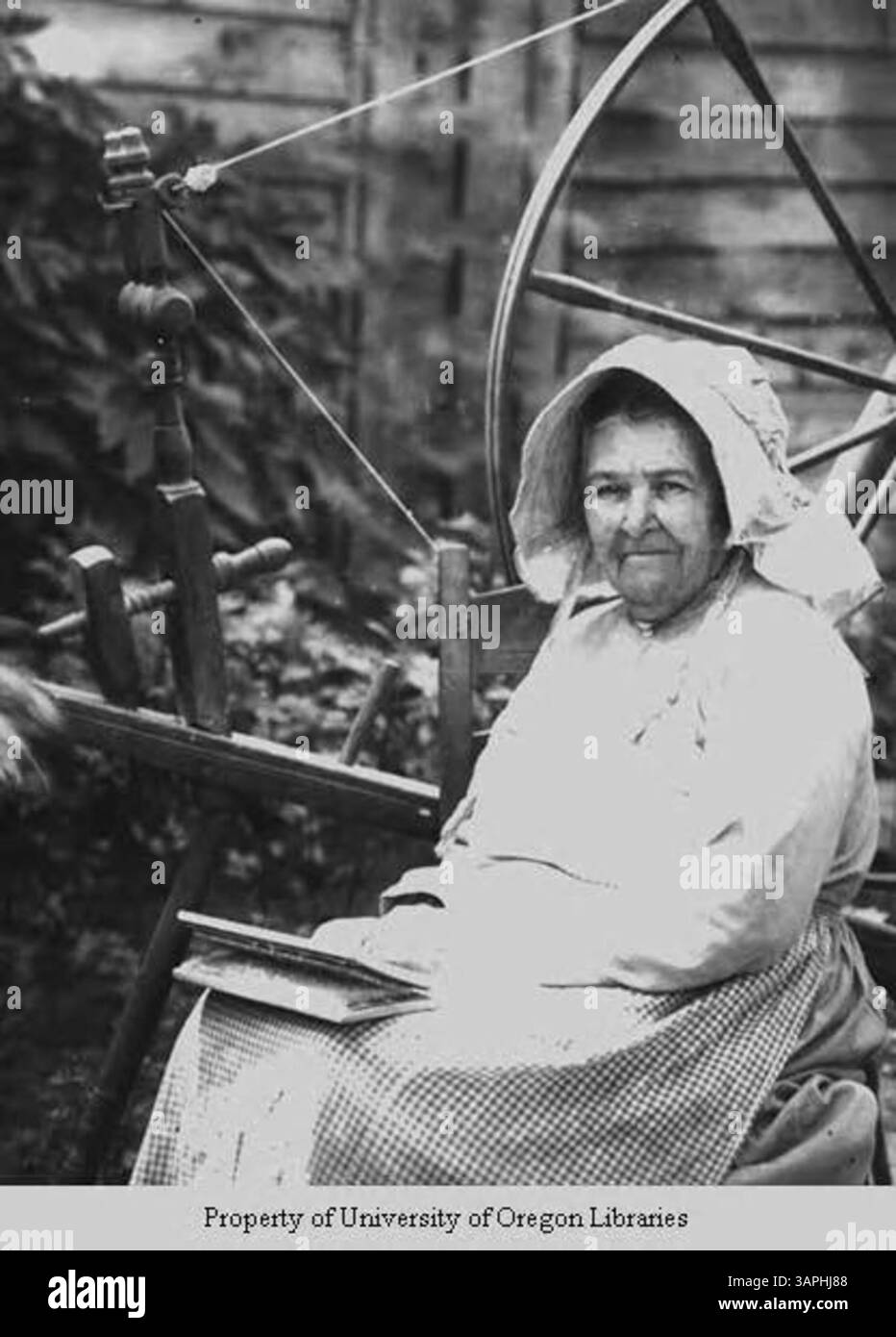Martha Nichols, a spinner and weaver, is shown in this photograph with ...
