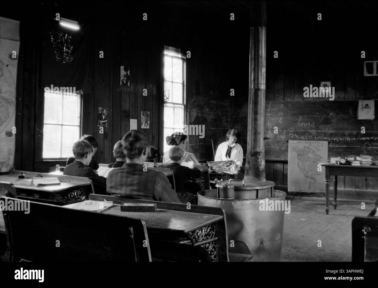This black-and-white photograph by Roy C. Andrews shows a classroom at ...