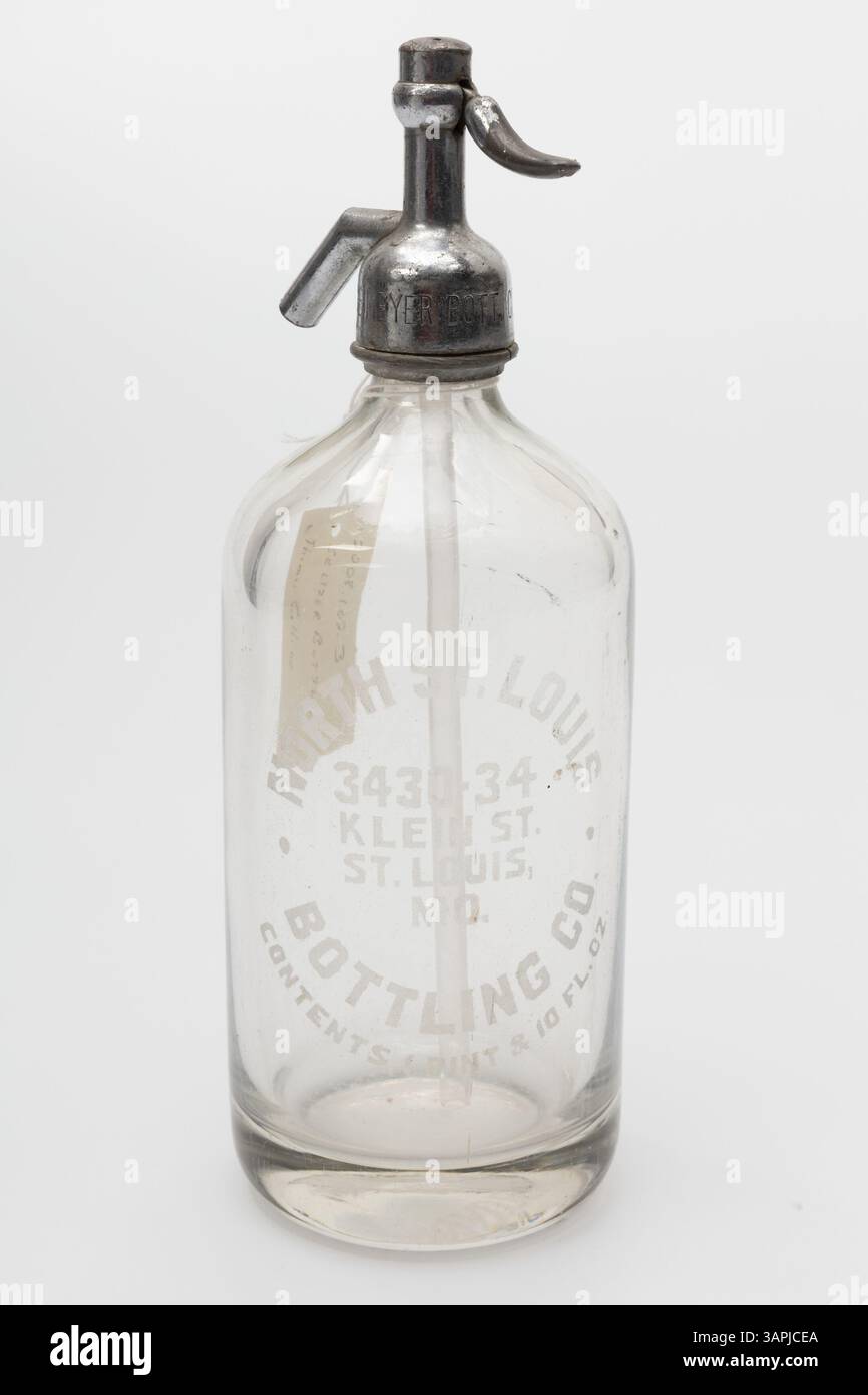 A clear glass seltzer bottle with a metal valve, used by the North St ...