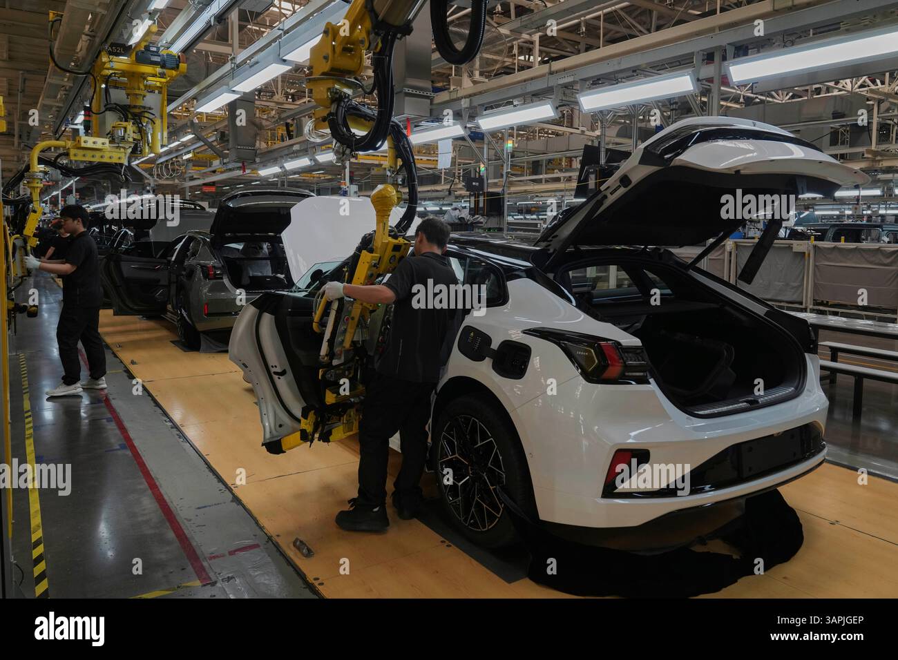 Workers assemble the Zeekr 001 EV models at the Chinese automaker Zeekr ...