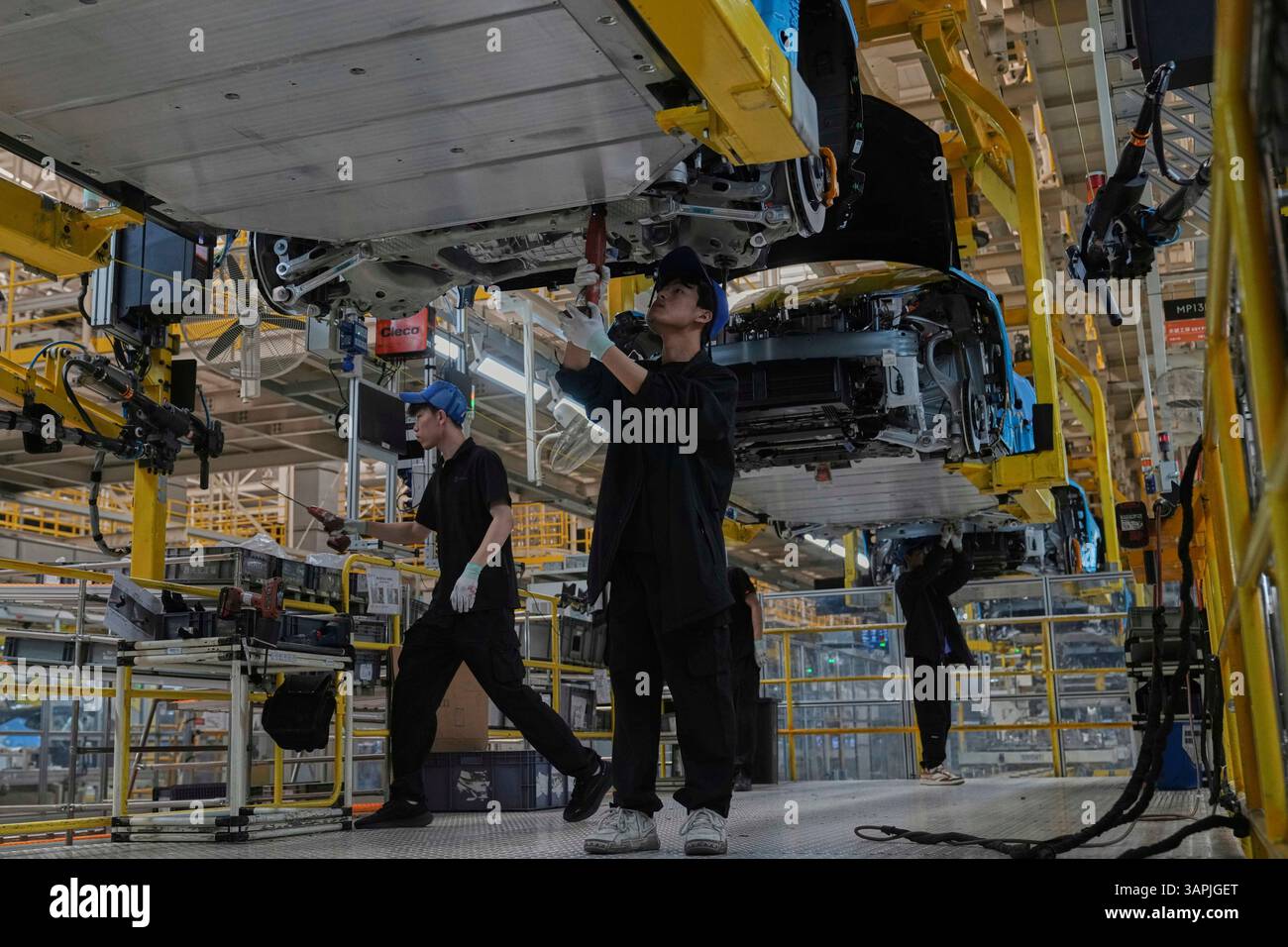 Workers assemble the Zeekr 001 EV models at the Chinese automaker Zeekr ...