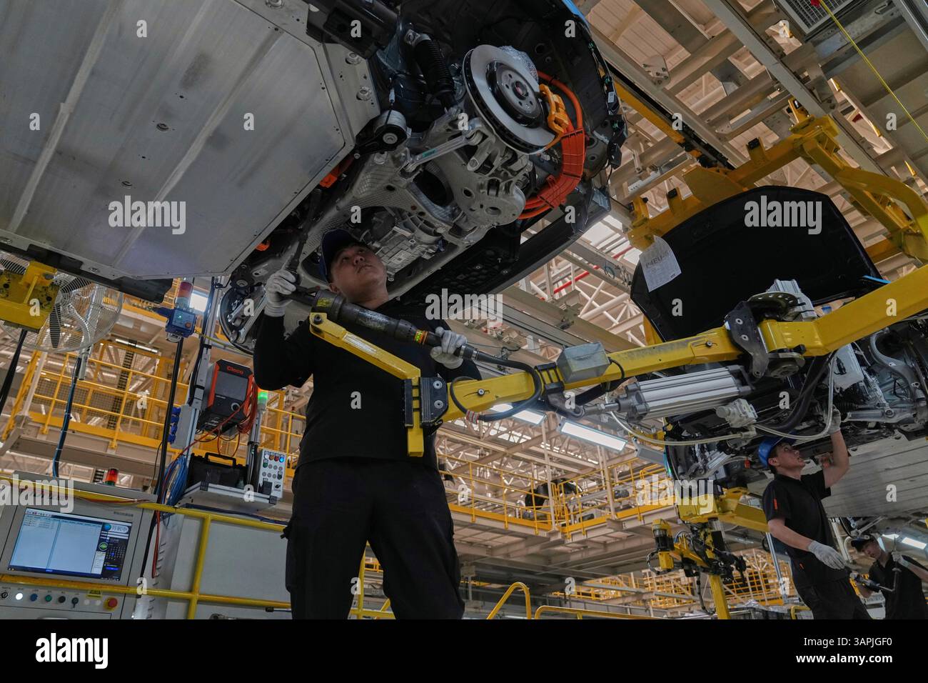 Workers assemble the Zeekr 001 EV models at the Chinese automaker Zeekr ...