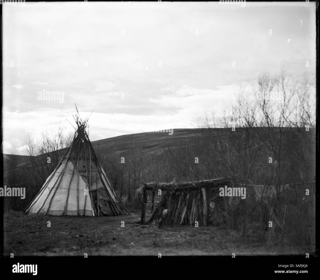 This Lee Moorhouse photograph captures a tipi by a stream, offering a ...